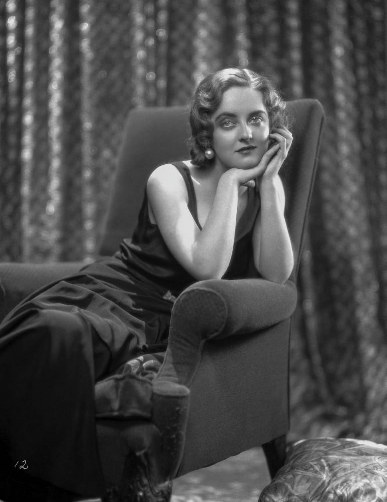 Bette Davis Seated on a Black Couch with Chin Leaning on Hand in Black ...