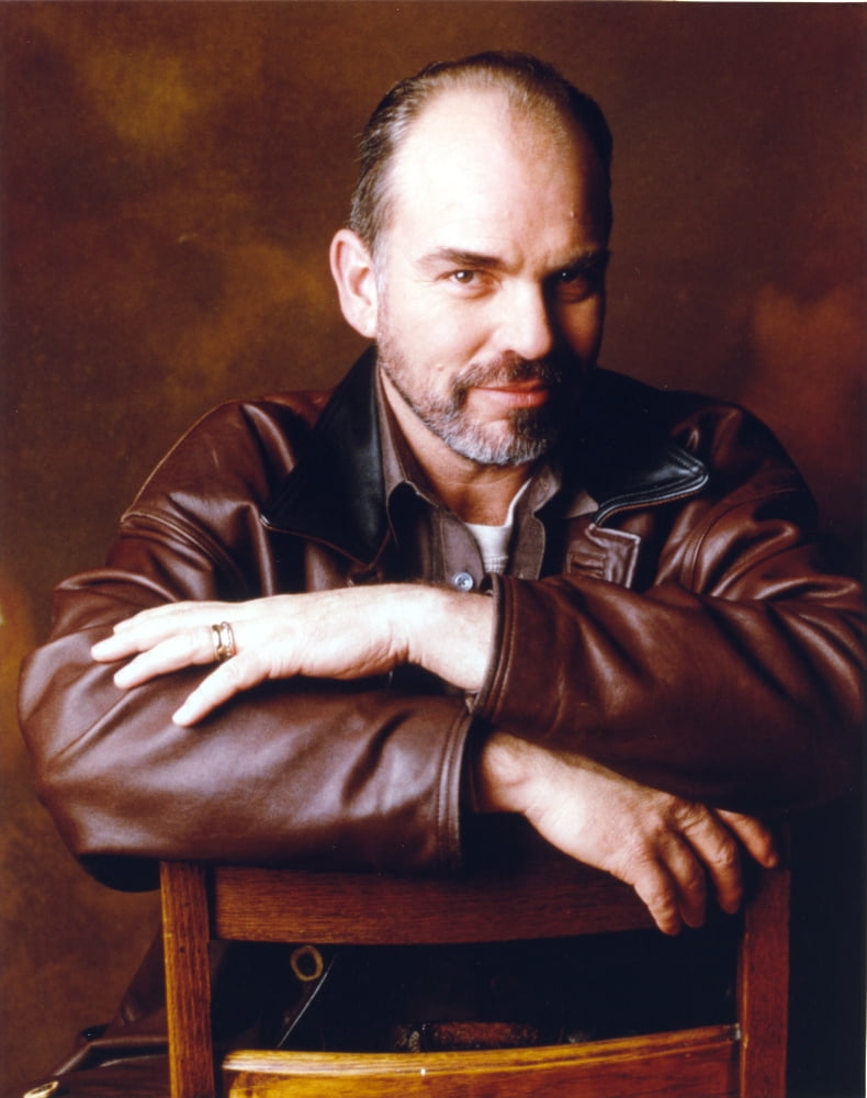 Billy Thorton Leaning on Chair in Brown Leather Jacket Portrait Photo ...