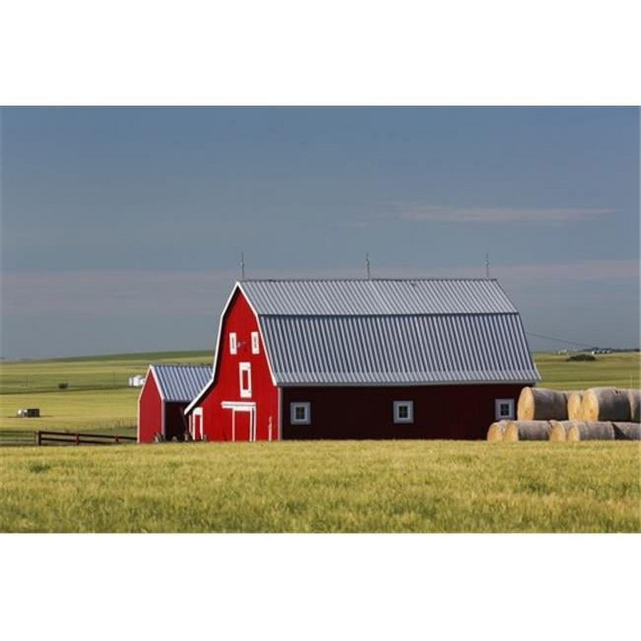 Bright Red Barn with Round Hay Bales in Green Grain Field with Blue Sky ...