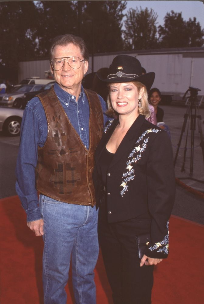 Burt Sugarman In Denim Outfit And Brown Leather Vest & Mary Hart In ...