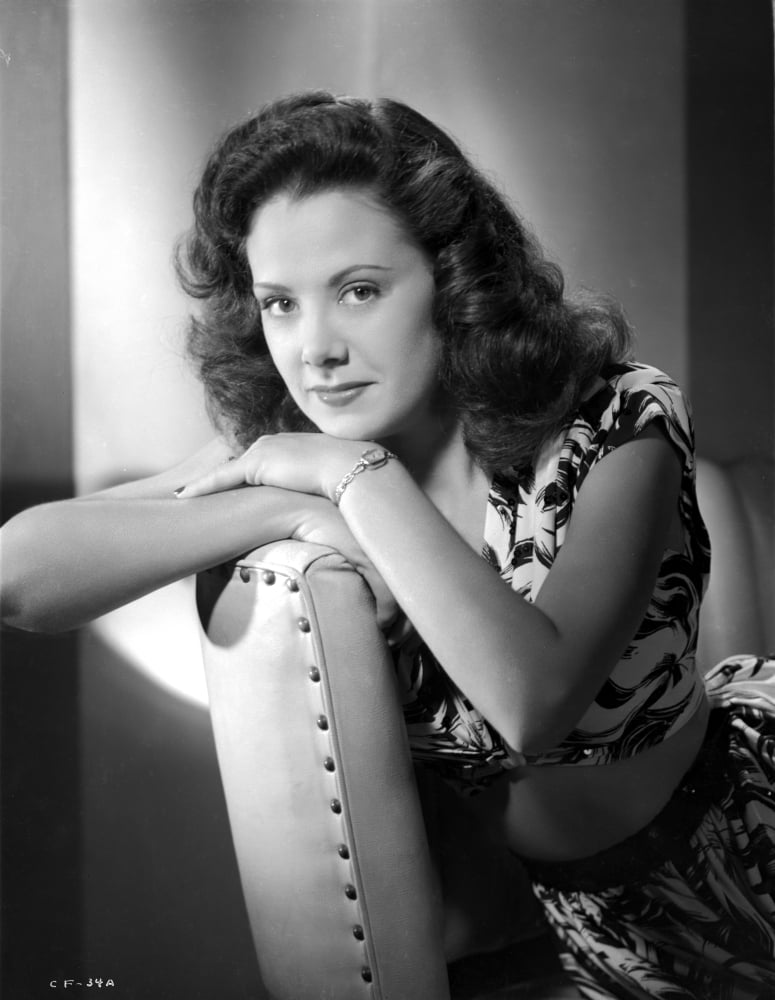 Carol Forman Posed in a Printed Dress and Hands and Chin Leaning on ...