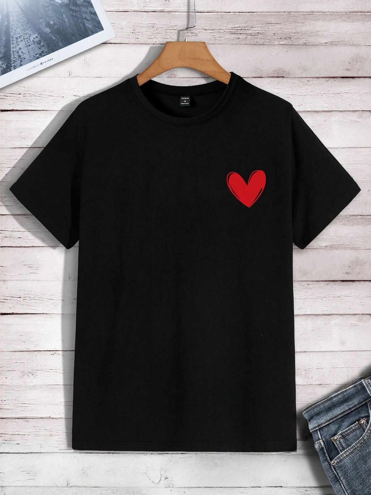 Classic black tee with a small red heart design, perfect for simple ...