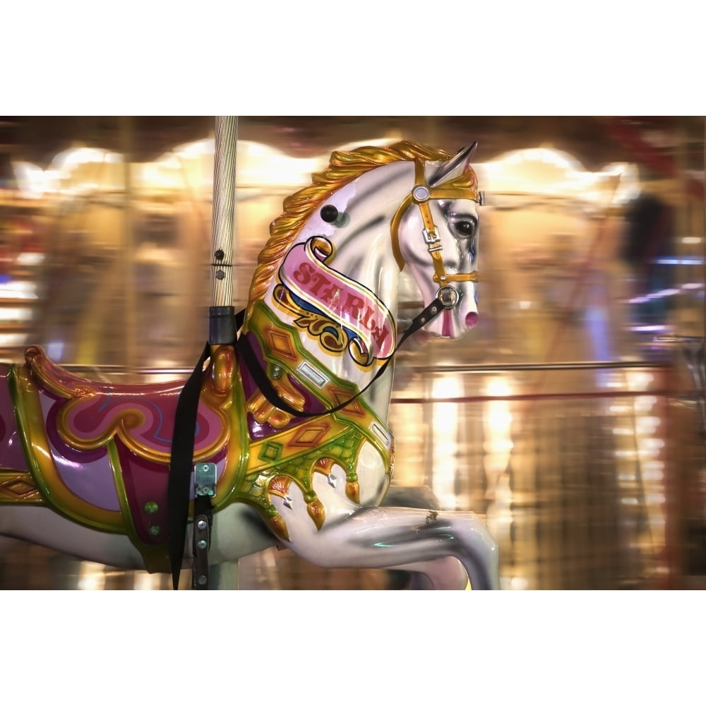 Close up of a painted horse on a carousel with blurred lights in the ...