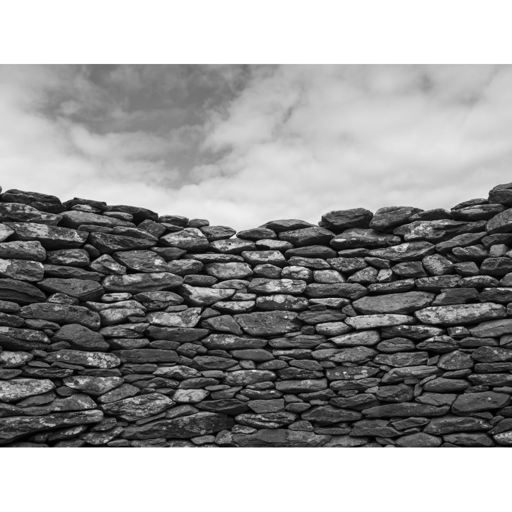 Close-up of a stone wall and clouds in the sky; Ballyferriter County ...