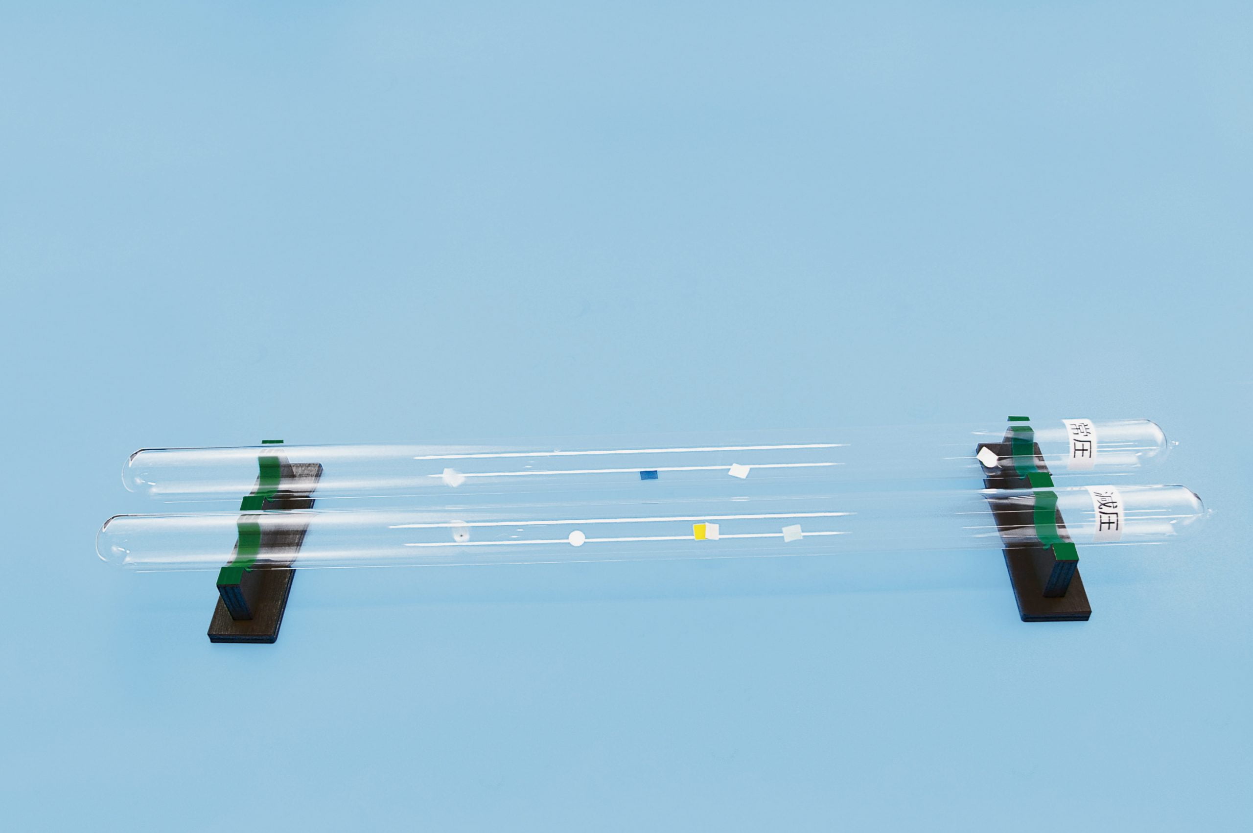 Free Fall Tubes. A set of 2 glass tubes under a vacuum that contain ...