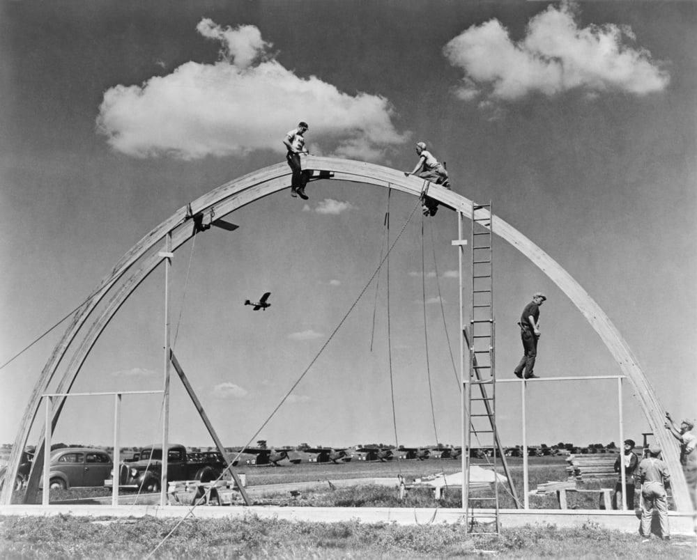 Construction Workers On Airplane Hangar With Prefabricated 'Rilco ...