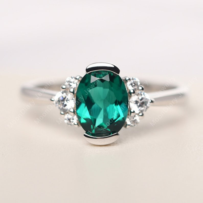 Custom emerald engagement ring with angel wings oval cut May birthstone ...