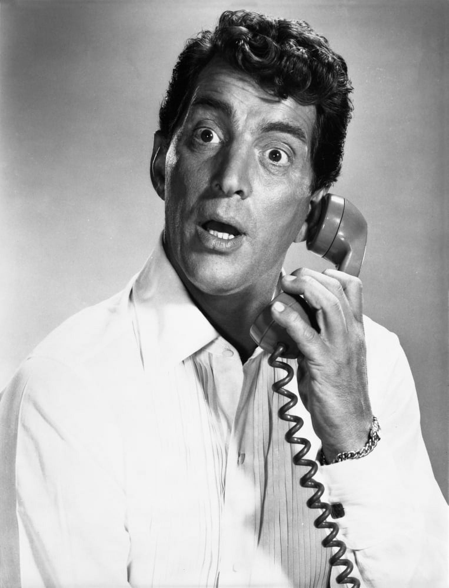 Dean Martin looking surprised while talking on a telephone Photo Print ...