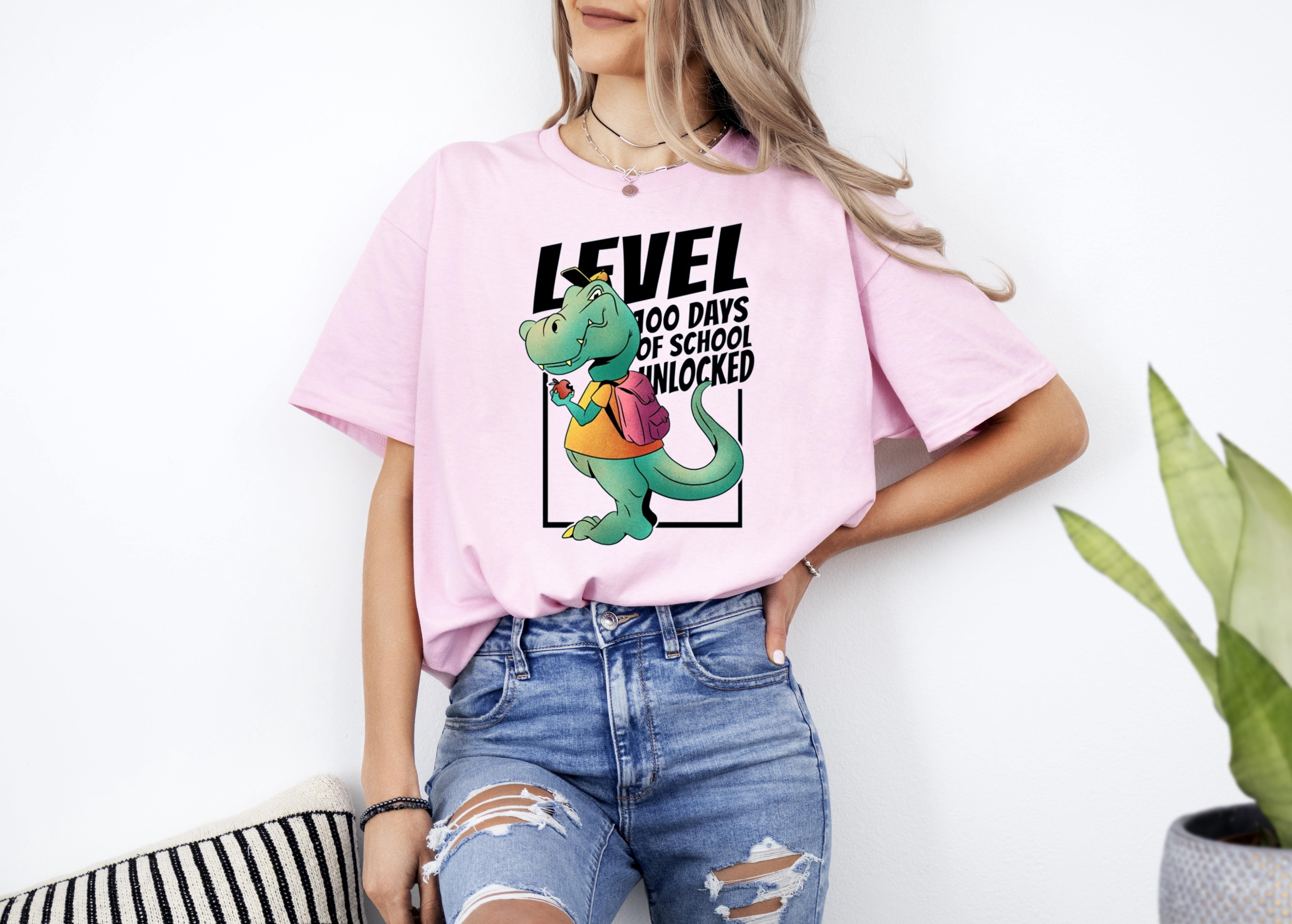 Dinosaur 100 days of school design on a T-shirt, featuring a cute ...