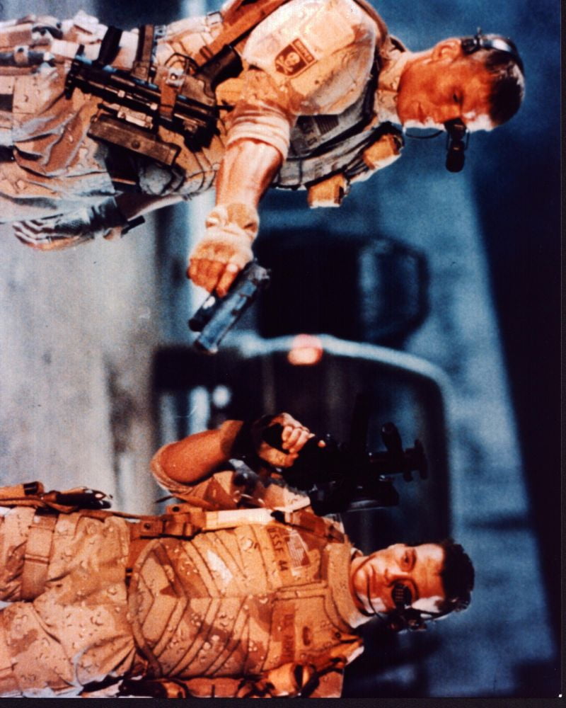 Dolph Lundgren And Jean-Claude Van Damme Holding Guns In Universal ...