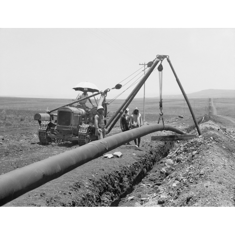 Dropping A Welded Pipe Into A Trench With A Crane While Laying The Iraq ...