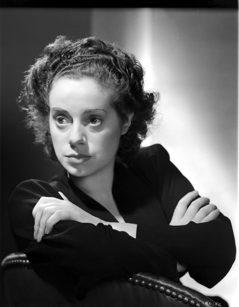Elsa Lancaster on a Long Sleeve Top and Crossing Hands on Chair Photo ...