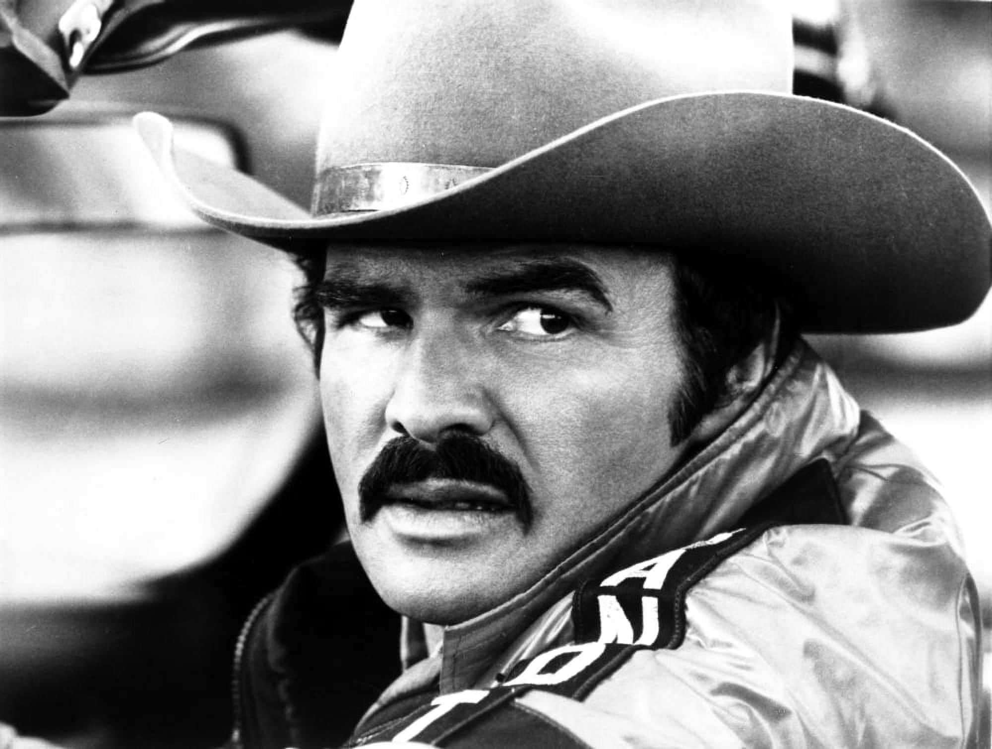 Film still of Burt Reynolds looking over his shoulder wearing a cowboy ...