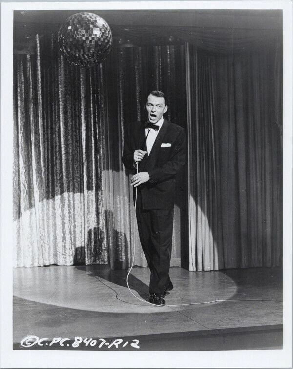 Frank Sinatra full length pose on stage in tuxedo holding microphone ...