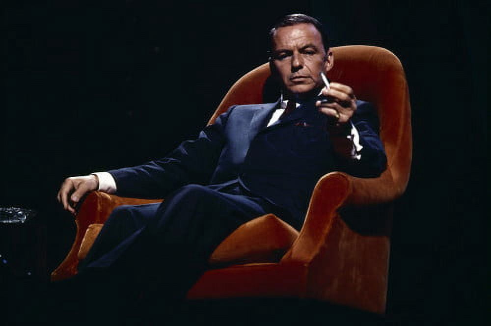 Frank Sinatra moody pose in suit relaxing in chair holding cigarette ...