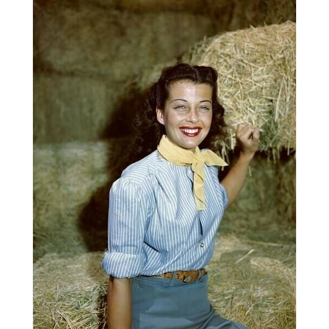 Gail Russell smiling portrait in blue shirt sits on bale of hay Poster ...