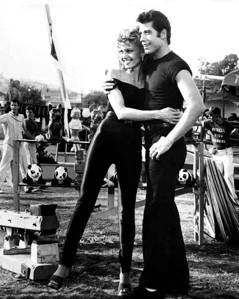 Grease Olivia Newton-John & John Travolta at fun fair hug each other ...