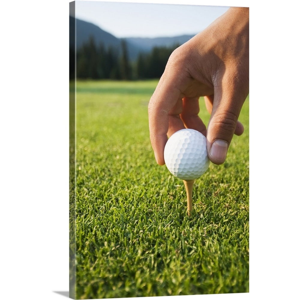 Great Big Canvas "Golfer sets up a ball on the tee of a golf course on ...