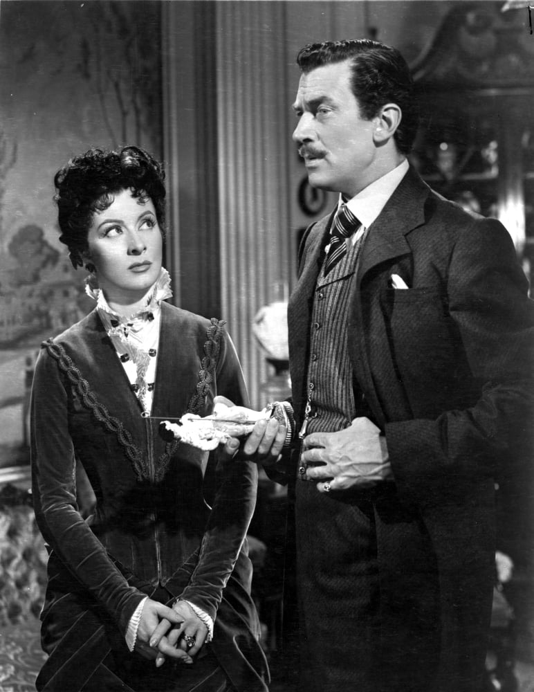 Greer Garson on a Long Dark Dress Listening to a Man Talking Portrait ...