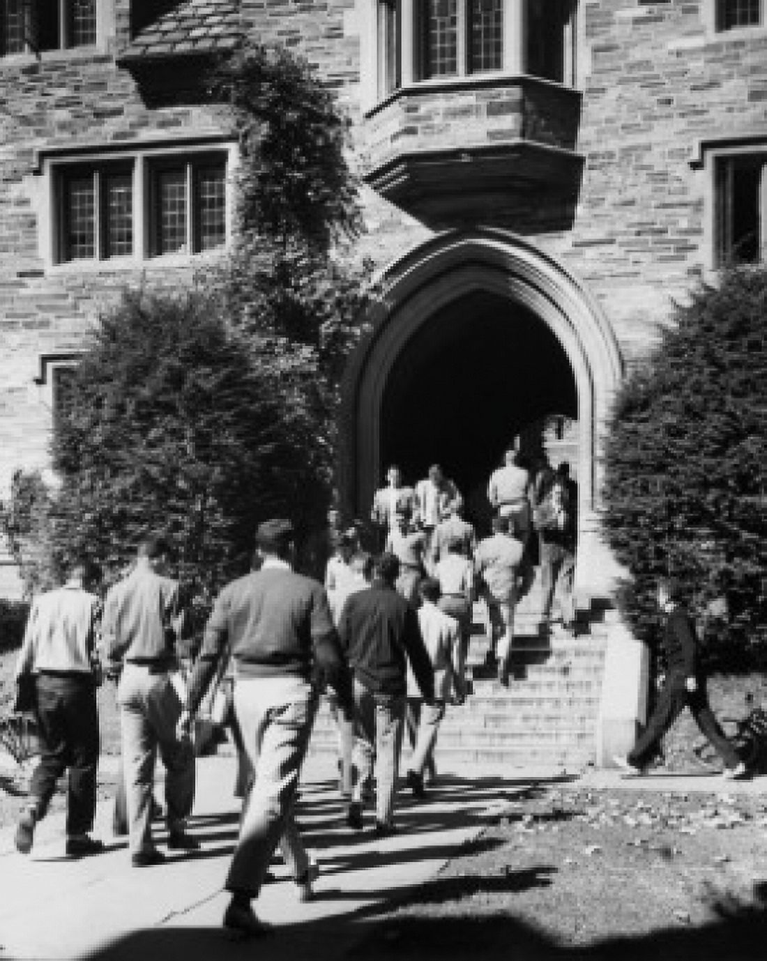 Group of people walking towards a university building, Holder Hall ...