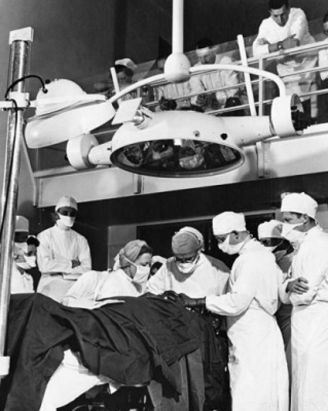Group of surgeons performing an operation in an operating room while ...