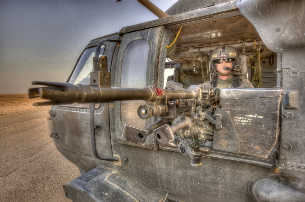 High dynamic range image of a UH-60 Black Hawk door gunner manning a ...