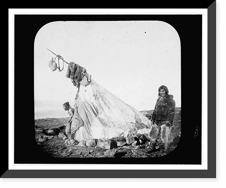 Historic Framed Print, [Inuit man standing next to tent and woman in ...