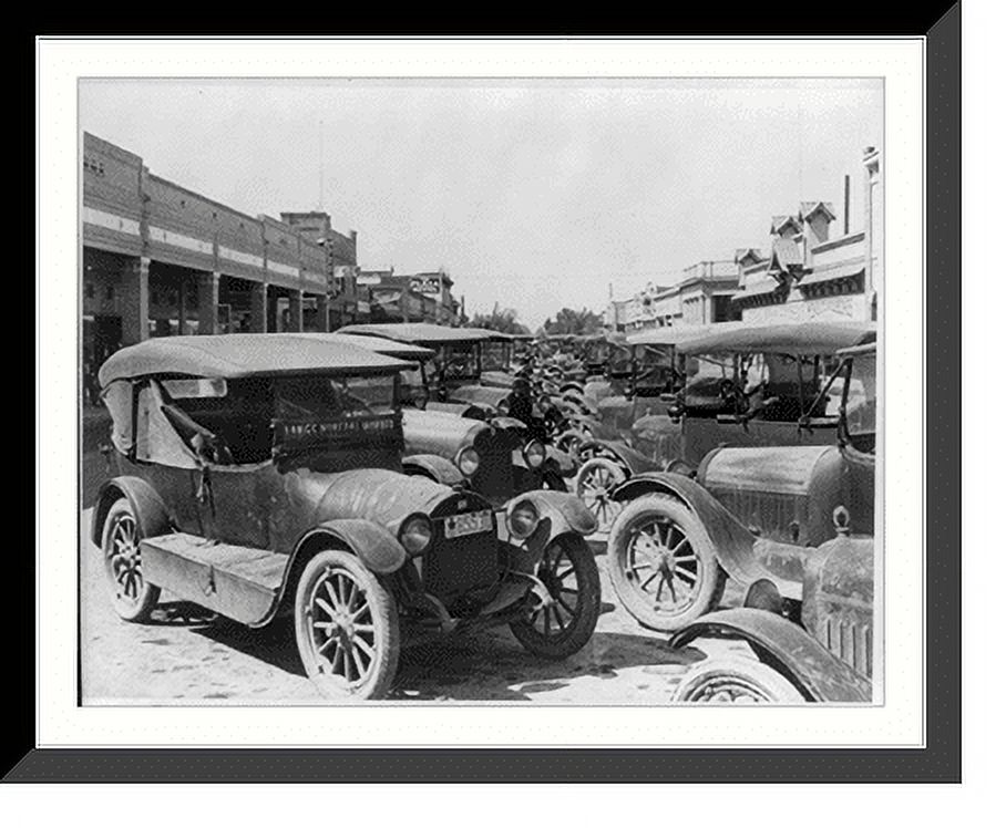 Historic Framed Print, [Looking down 2 rows of autos parked diagonally ...