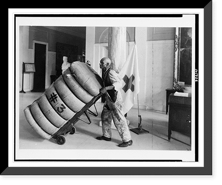 Historic Framed Print, [Man pushing bundles, possibly cotton on dolly ...