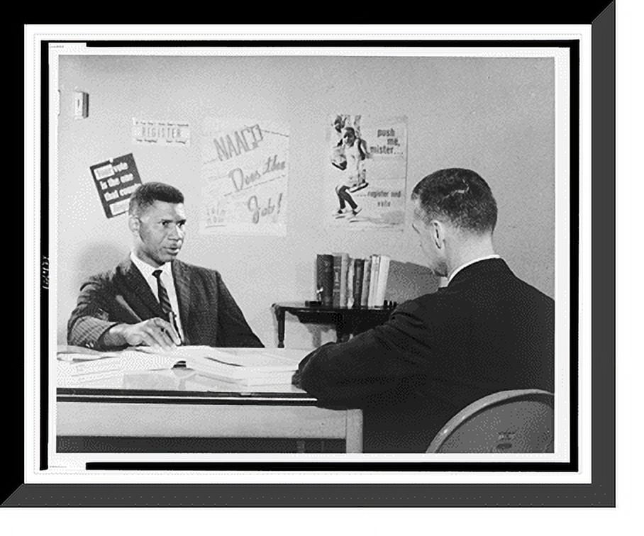 Historic Framed Print, [Medgar Evers, seated behind desk, being ...