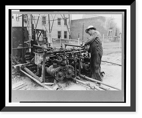 Historic Framed Print, Oil field worker working on the mud hog, a ...