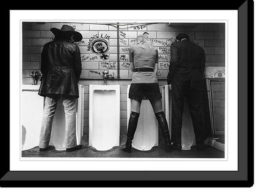 Historic Framed Print, [Two men and a woman standing at urinals, with ...
