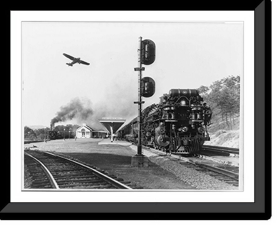 Historic Framed Print, [Two trains, with airplane overhead, at the ...