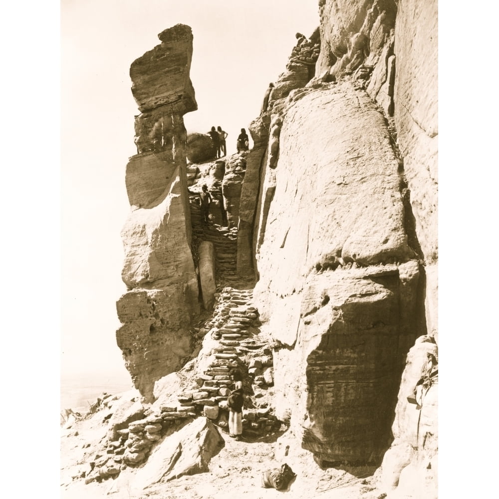 Hopi Indians along steps up rocks, leading to pueblo on mesa, Walpi ...