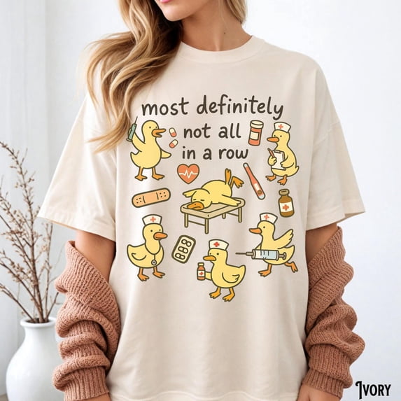 Ivory T-Shirt with Cartoon Ducks in Medical Roles and "Most Definitely ...