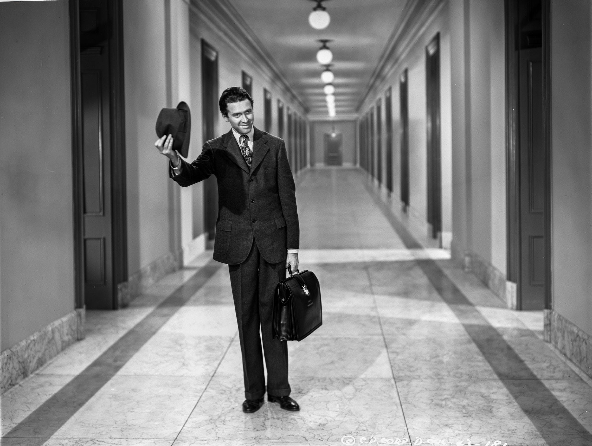 James Stewart Posed in Black Suit and Necktie with Right Hand Holding a ...