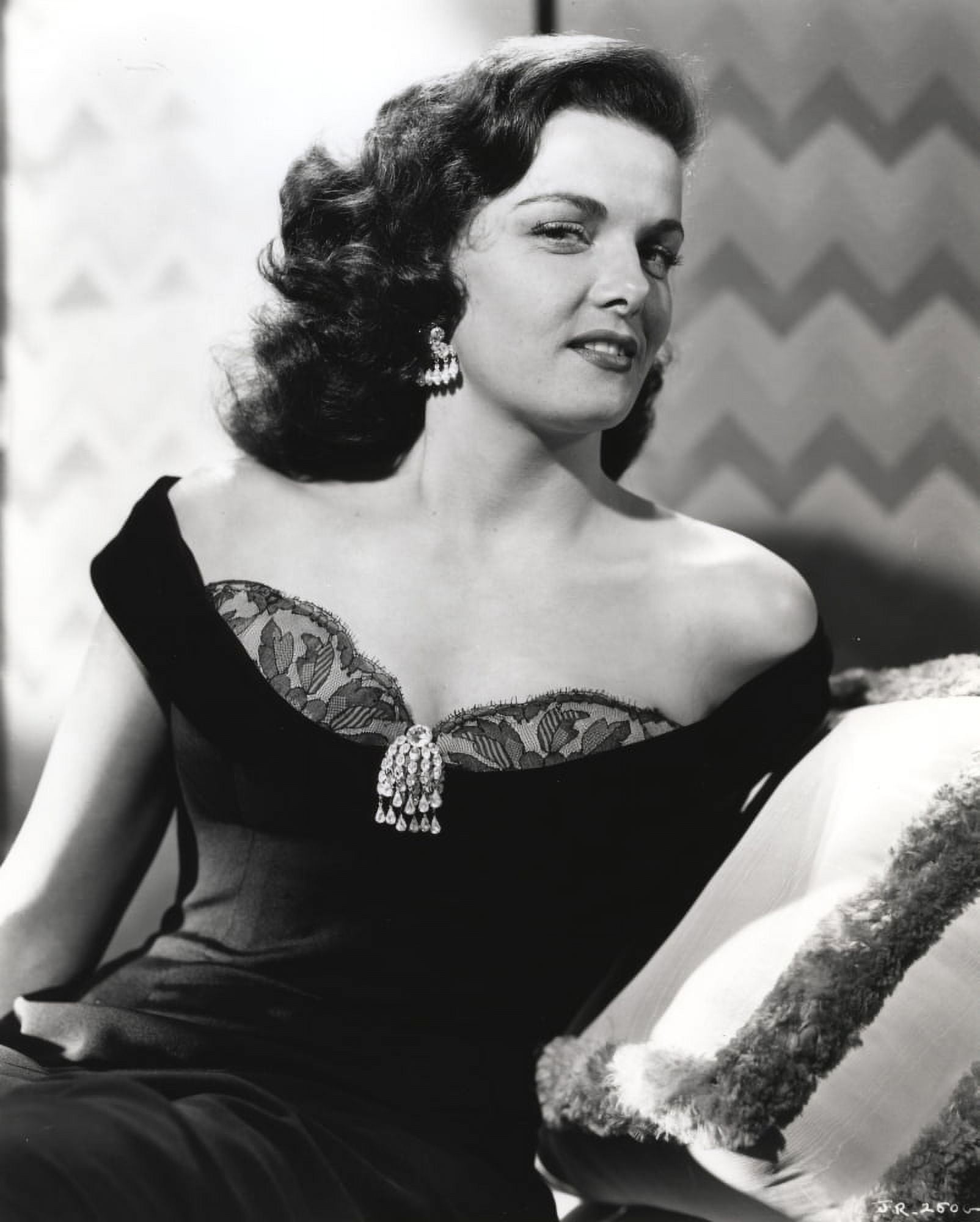 Jane Russell Seated on a Couch in Black Lace Top Shoulder Dress with ...