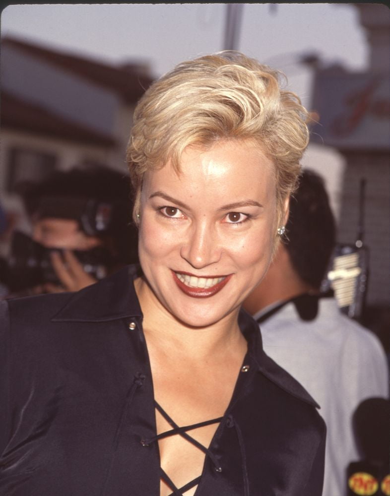 Jennifer Tilly Close Up With Short Blond Hair And Black Lace Up Shirt A ...