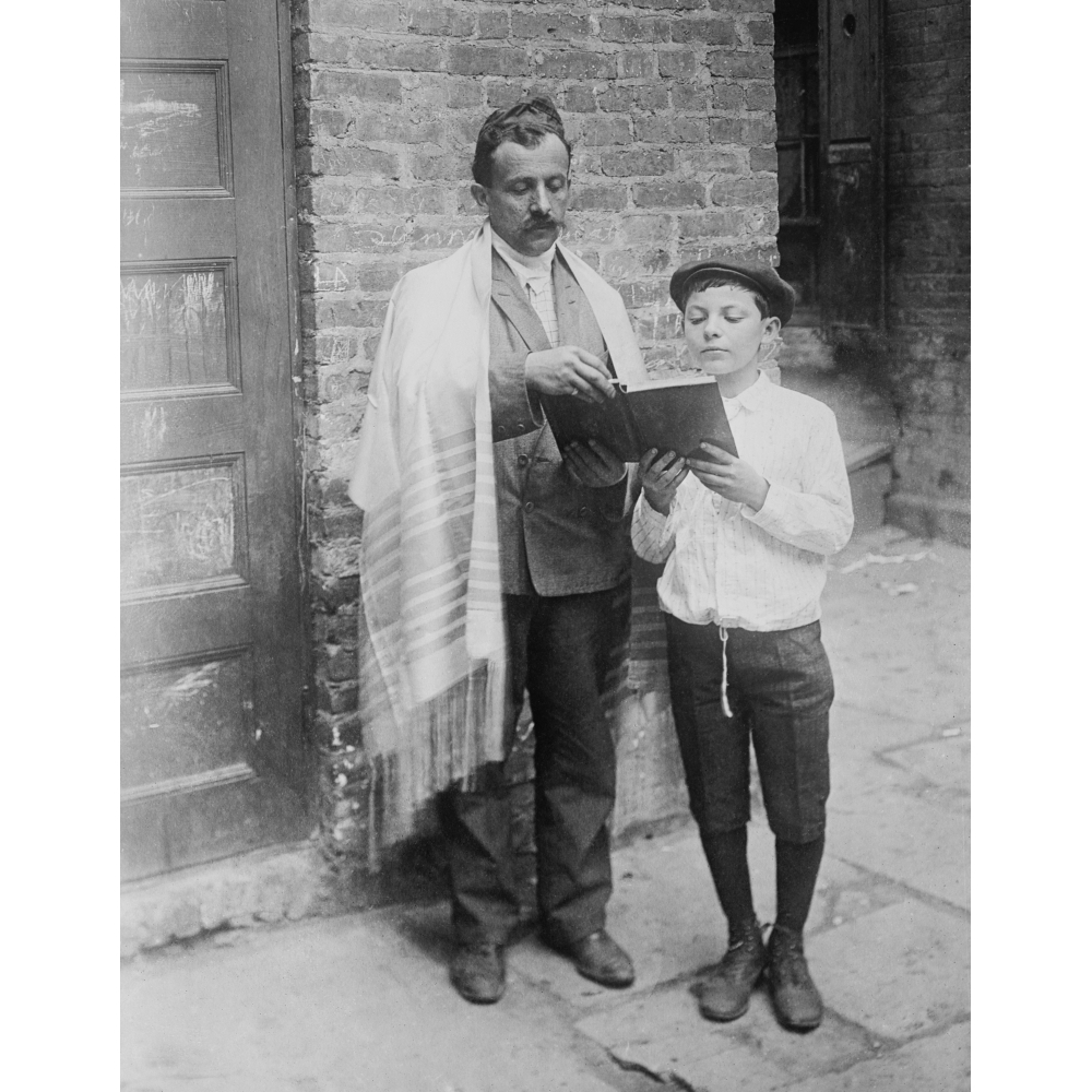 Jewish Man Wearing A Prayer Shawl And Boy Reading From Hebrew Bible On ...
