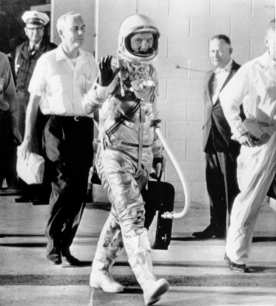 John Glenn Gives A Jaunty Wave To Photographers As He Strides From The ...