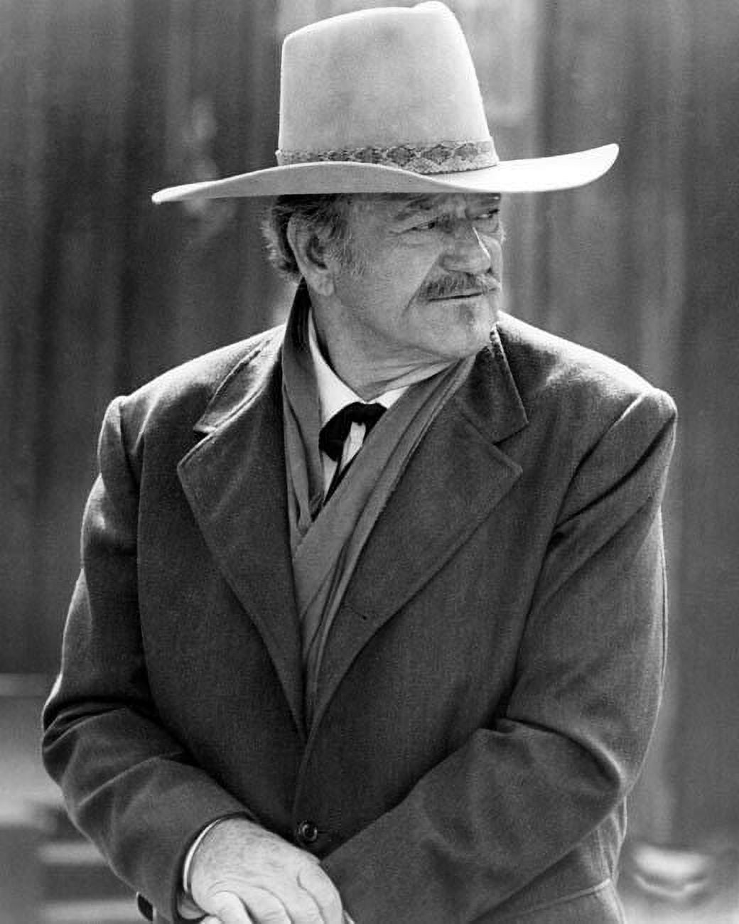 John Wayne as J.B. Books wearing western overcoat on horse The Shootist ...