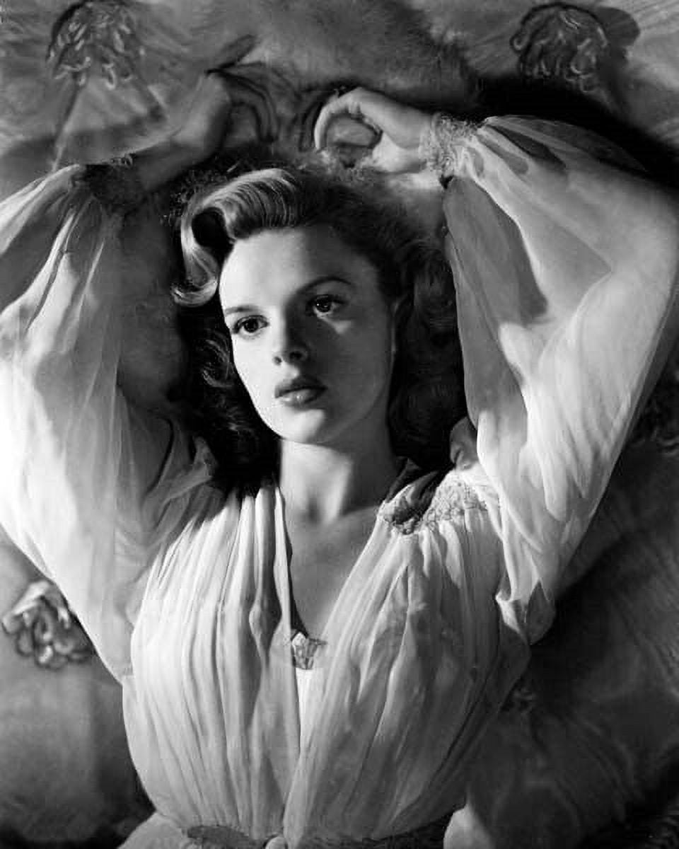 Judy Garland looks voluptuous in this 1940's glamour pose arms raised ...