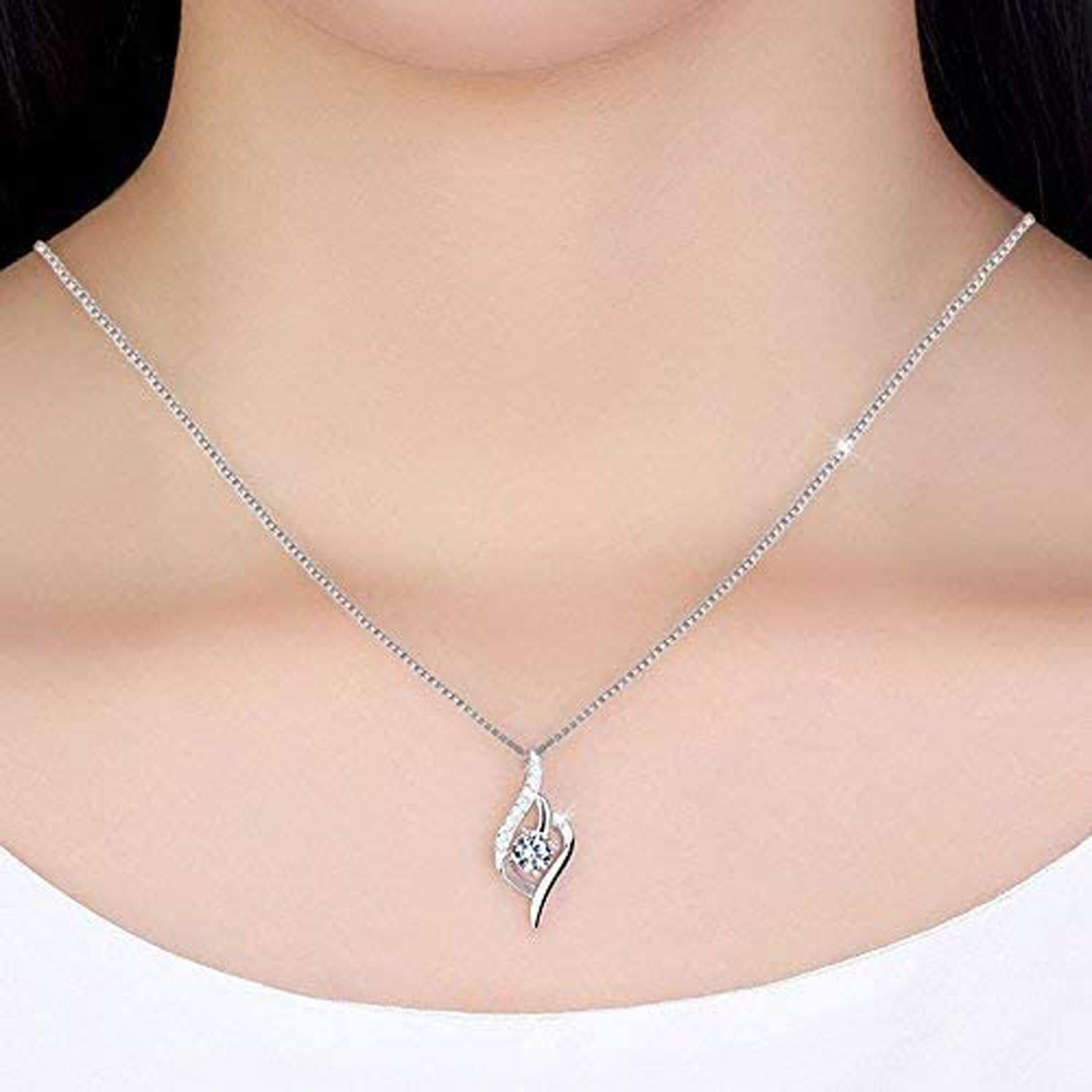 LILELIS Jewelry A silver pendant on a woman's necklace a silver ...