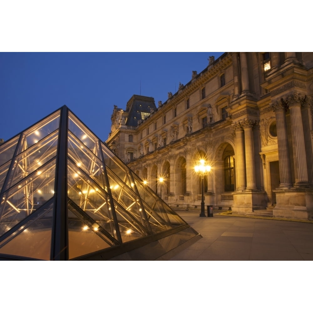 Le Louvre palace buildings and pyramids at night in golden light; Paris ...