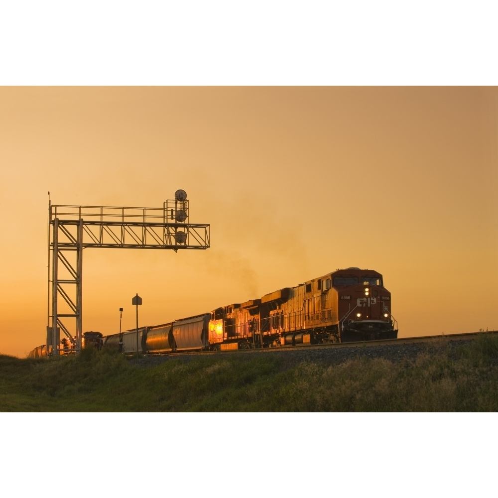 Locomotives Pulling Rail Hopper Cars Pass An Overhead Rail Signal Near ...