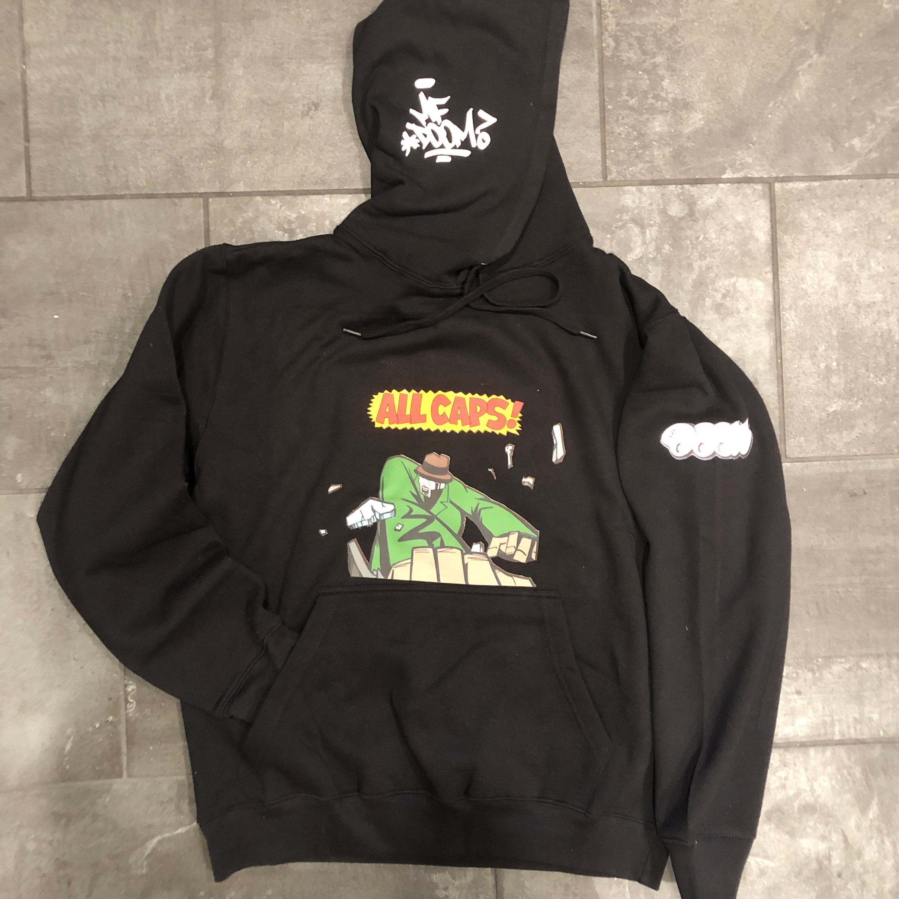 MF DOOM Madvillain All Caps. Black hoodie with white graphics ...