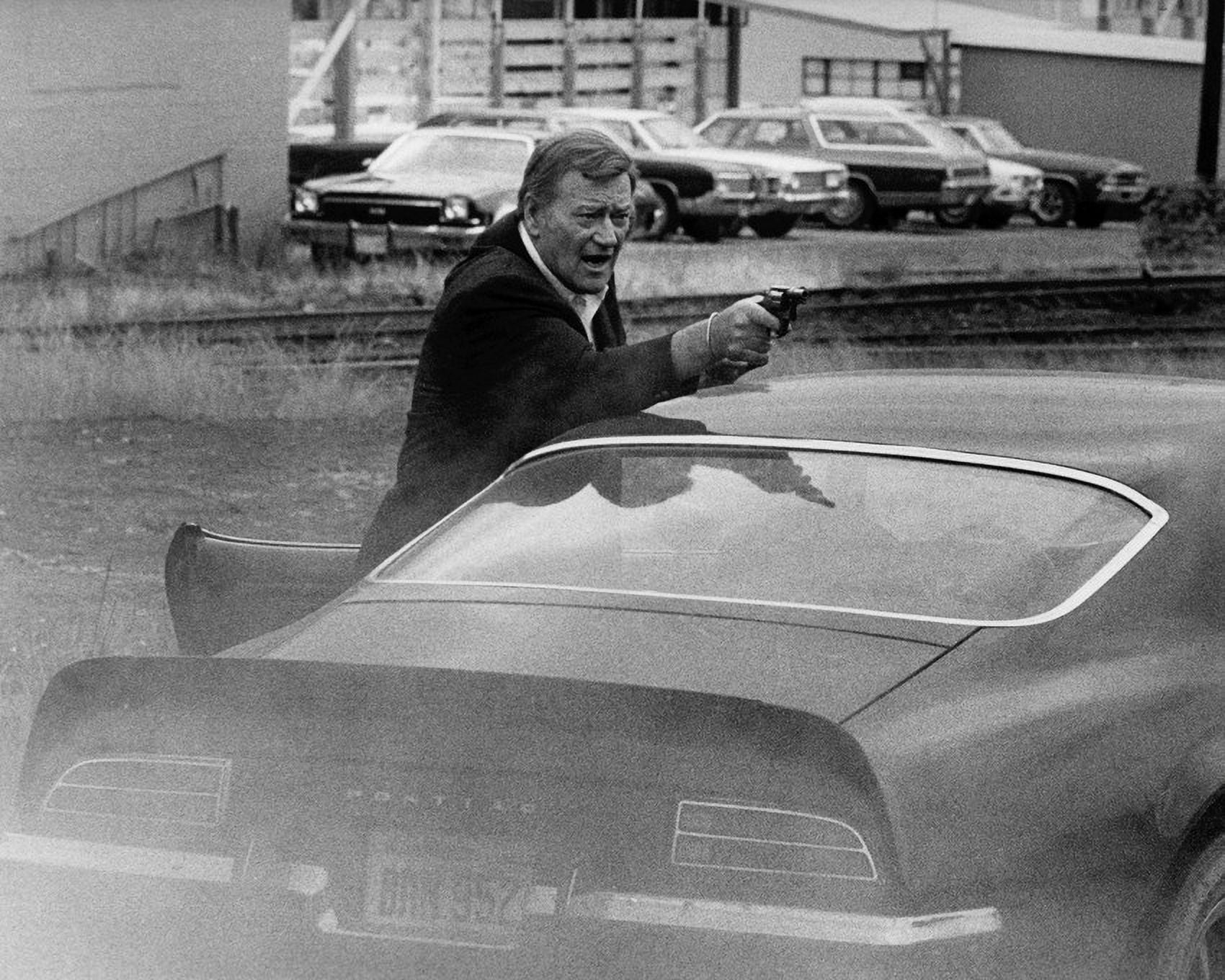 McQ John Wayne pointing gun by Pontiac Firebird Trans Am 24X36 Poster ...