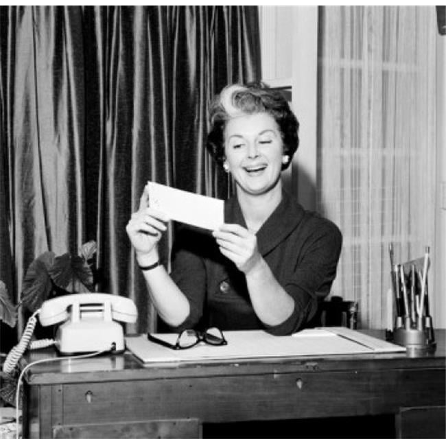 Mid Adult Woman Sitting at Desk & Holding Paycheck Poster Print - 18 x ...
