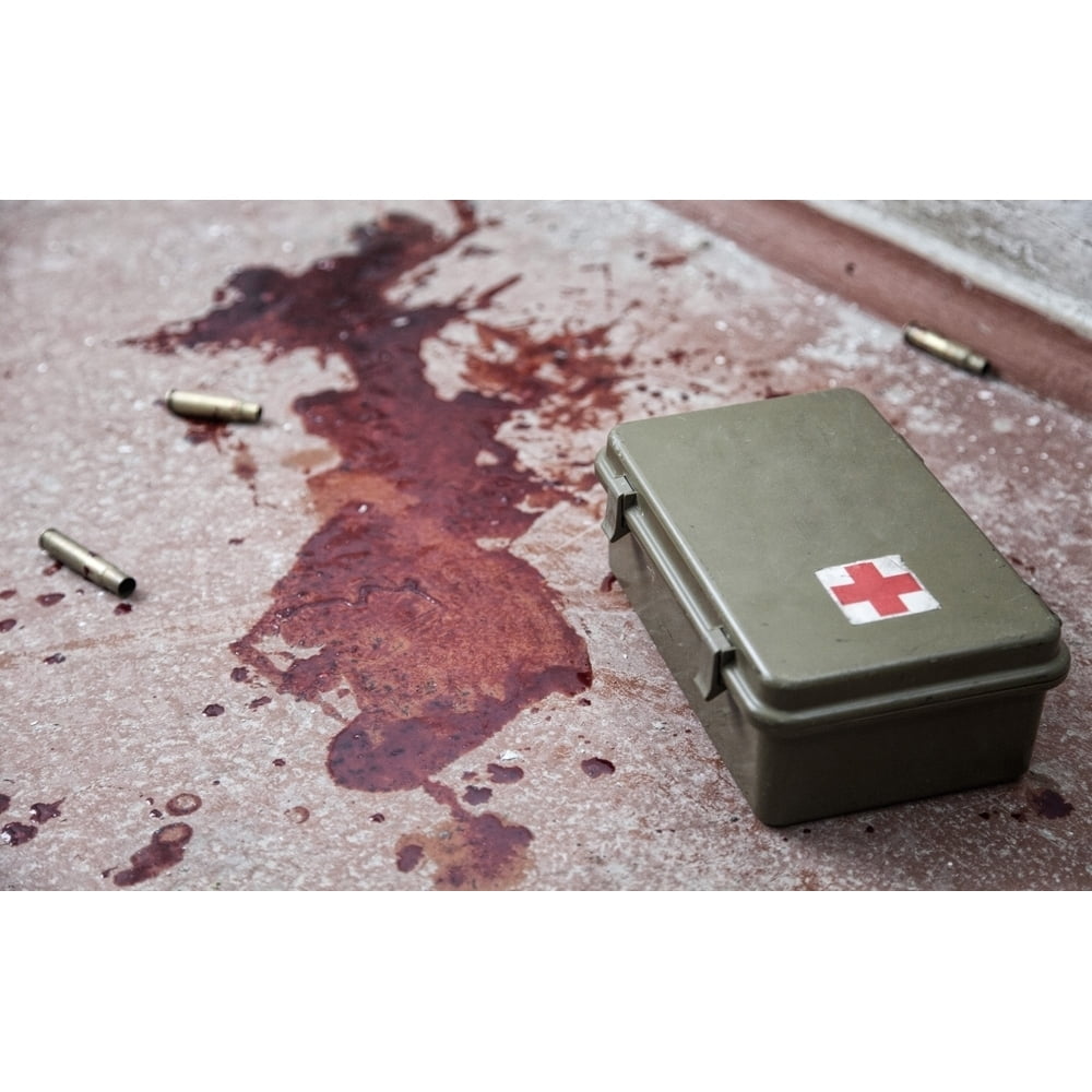Military first aid kit on floor with empty bullet casings and stains of ...