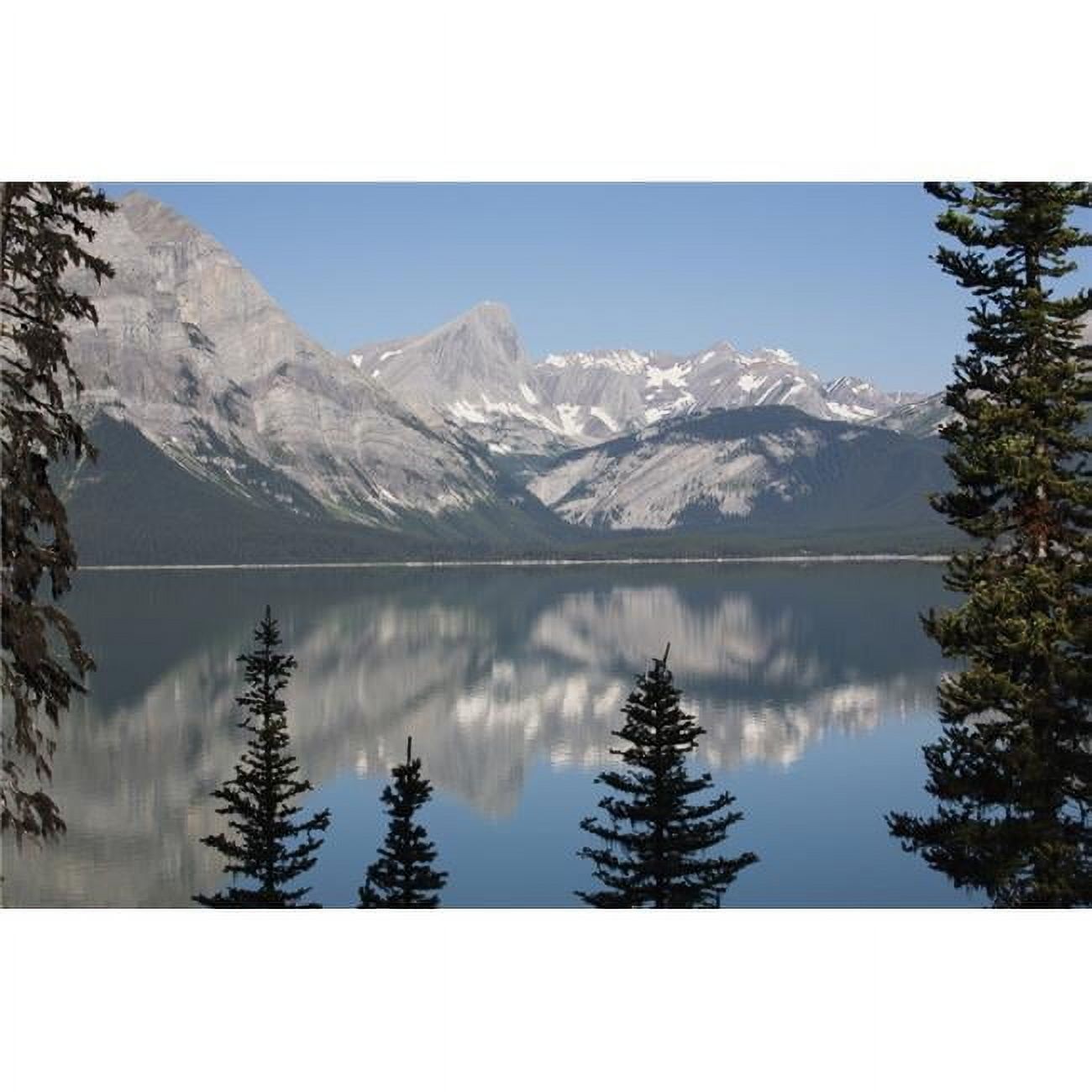 Mountain lake reflecting mountain range with snow and blue sky framed ...